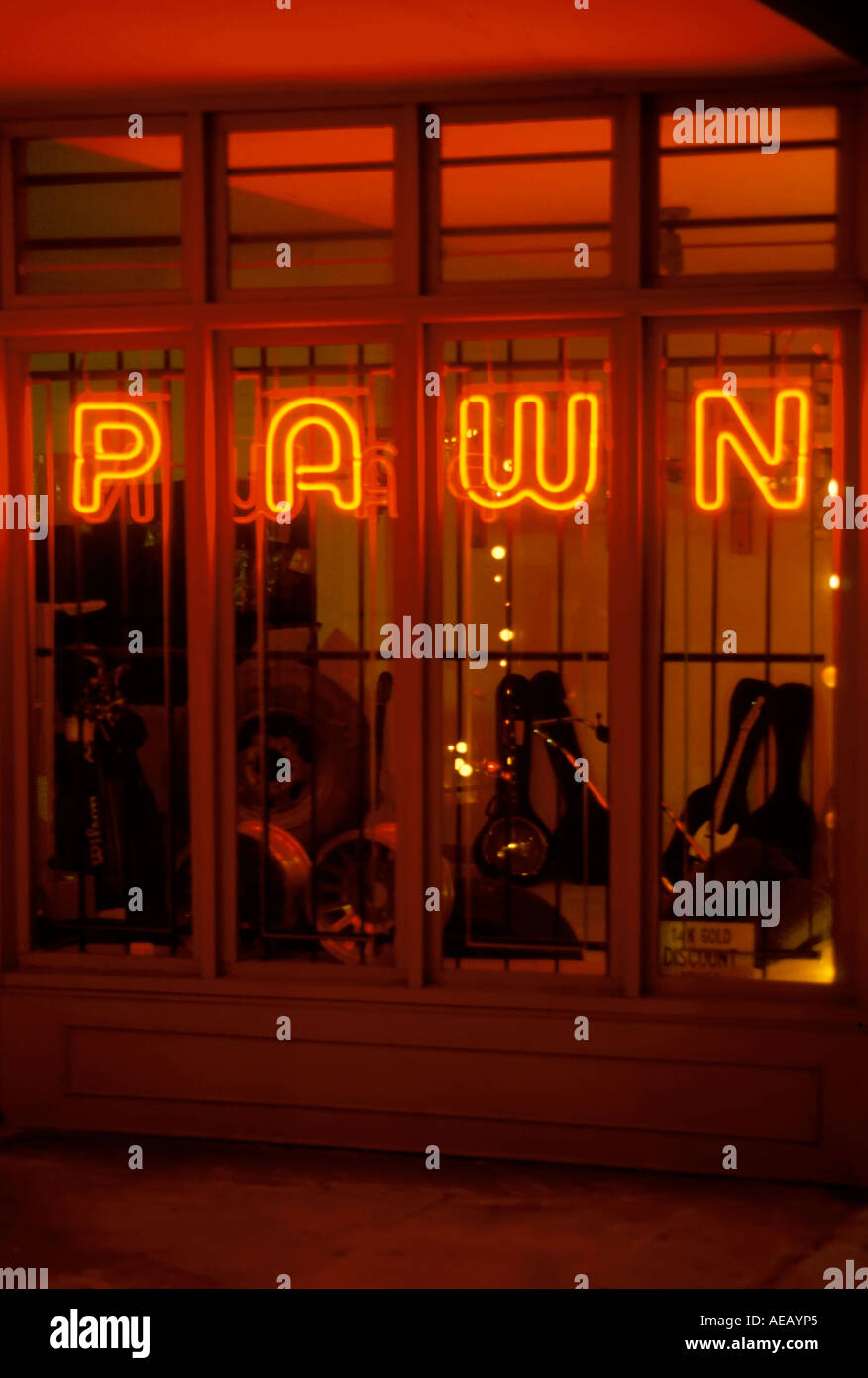 Pawn shop sign lit up at night Stock Photo - Alamy