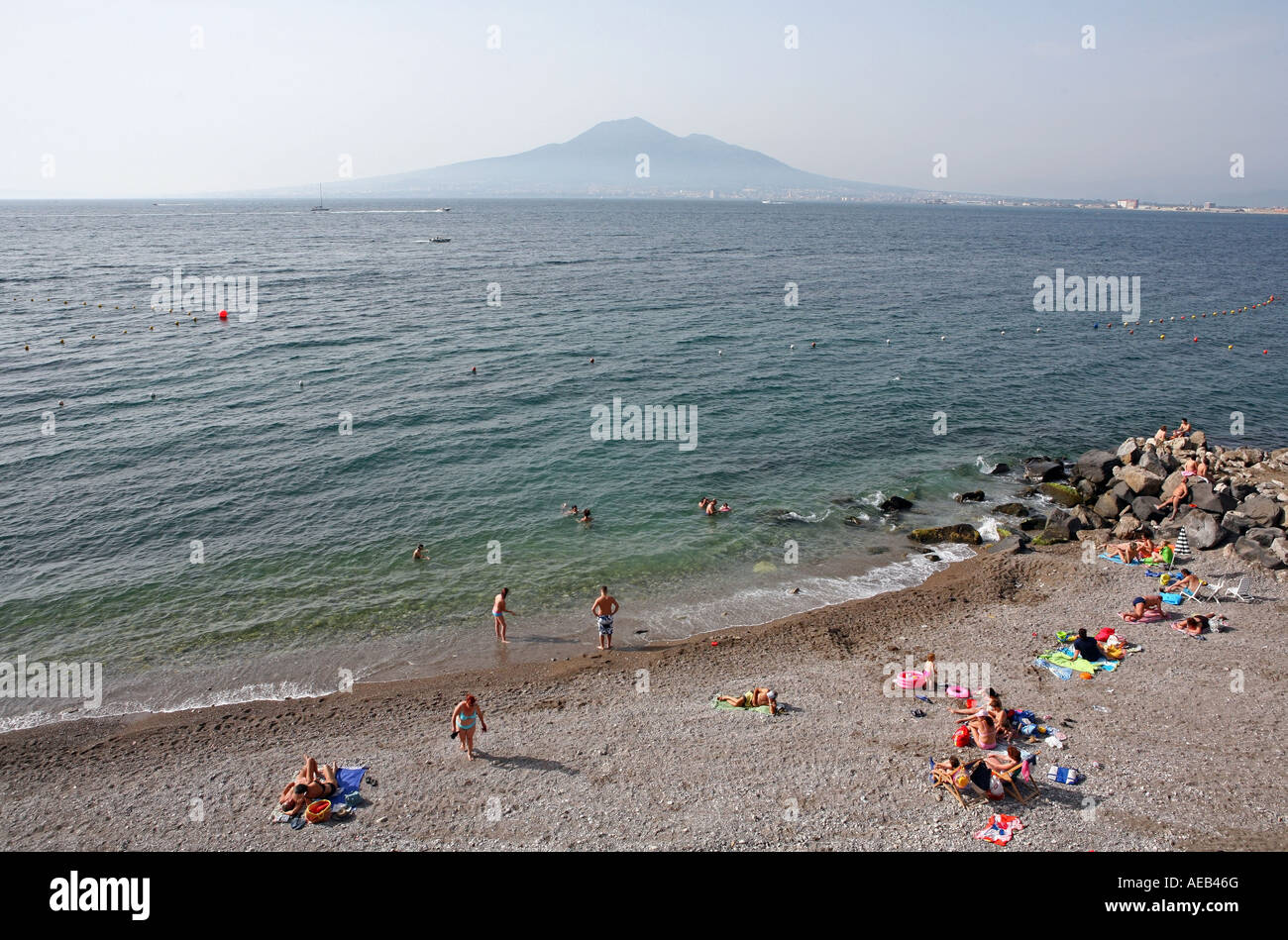 View on mount Vesuvius from rocky beach in Italy Stock Photo - Alamy