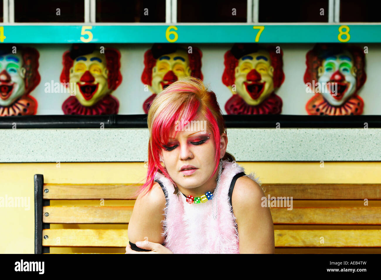 Young Hispanic punk female sitting in front of carnival booth Stock ...