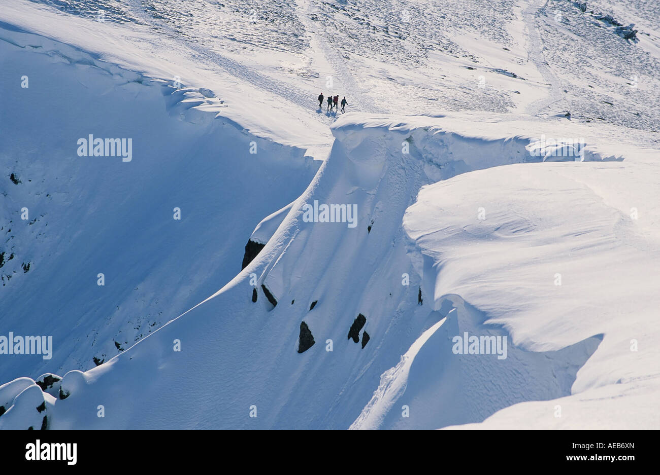 Hill walkers on Helvellyn in winter time with large cornices Stock ...