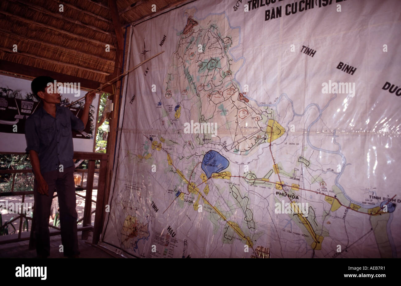 Party official gives a briefing on Vietnam war to tourists at Chu Chi ...