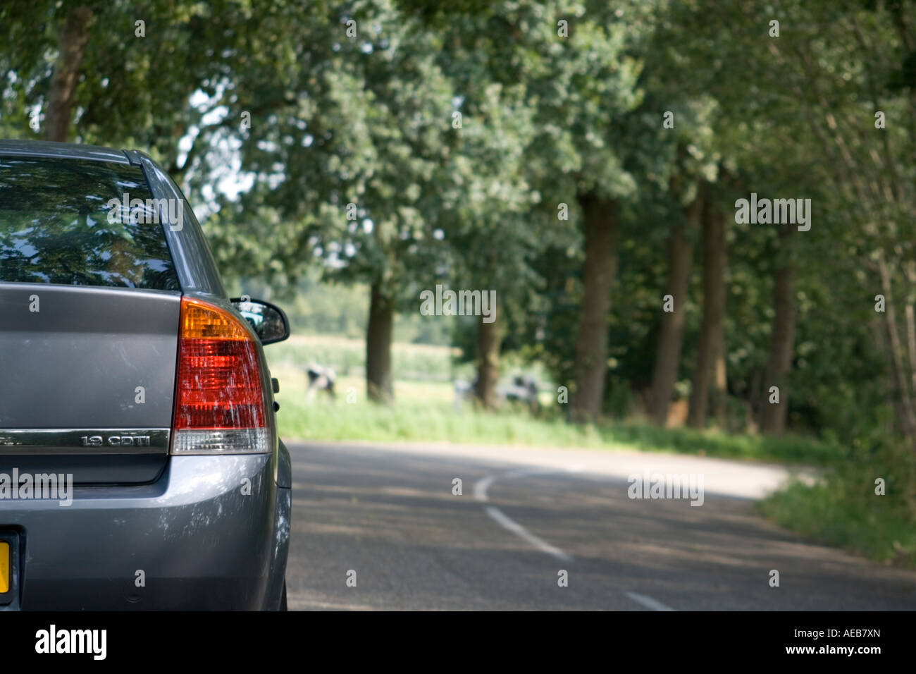 Car approacing a road bend Stock Photo - Alamy