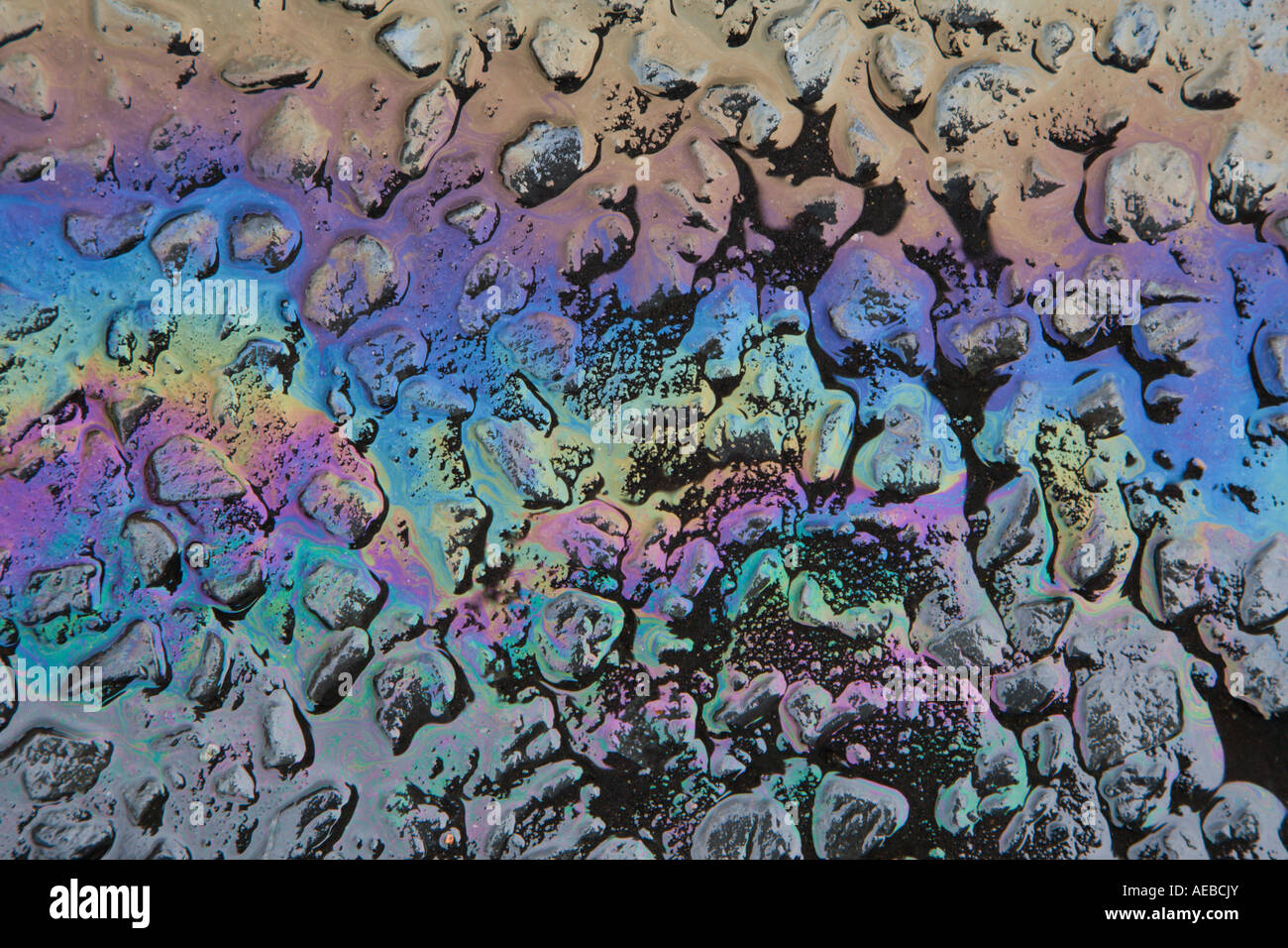Pattern made by oil on road surface Stock Photo - Alamy