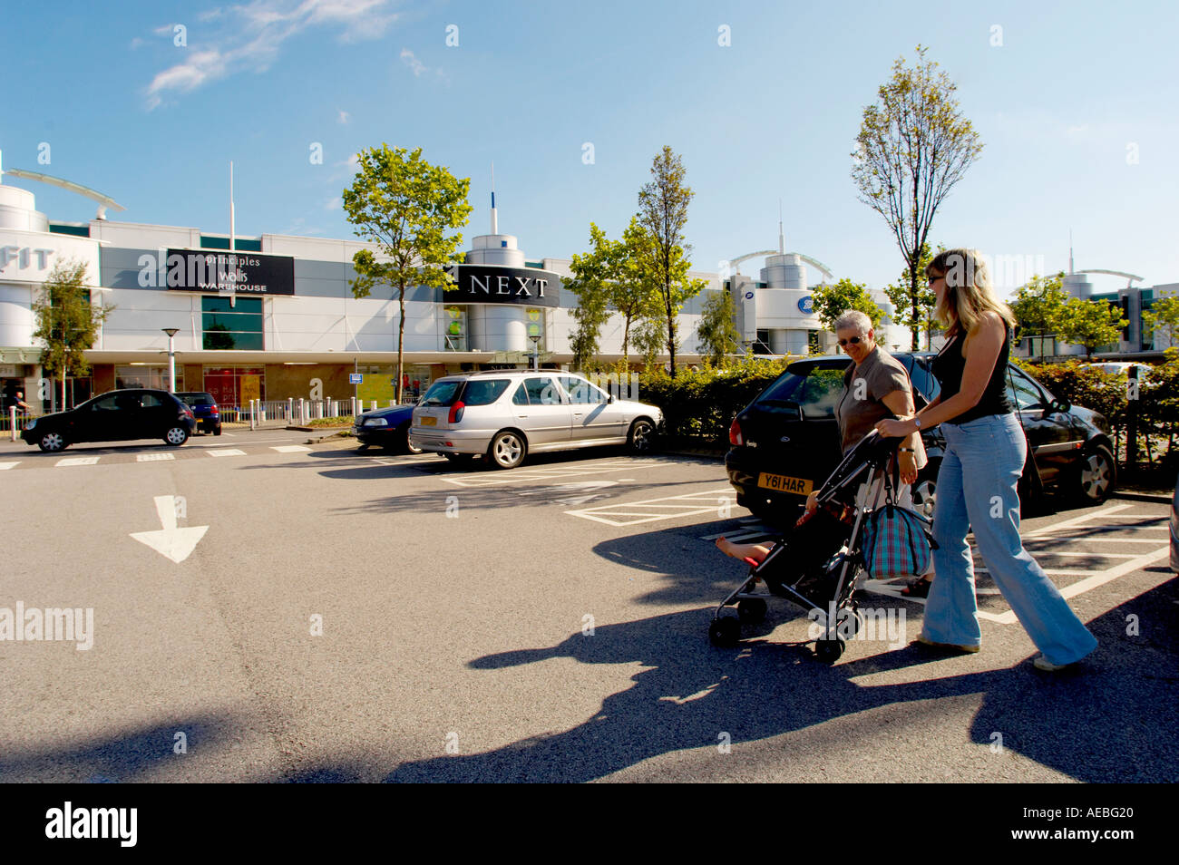 Female shopper with pushchair arriving at Monks Cross Shopping Park ...