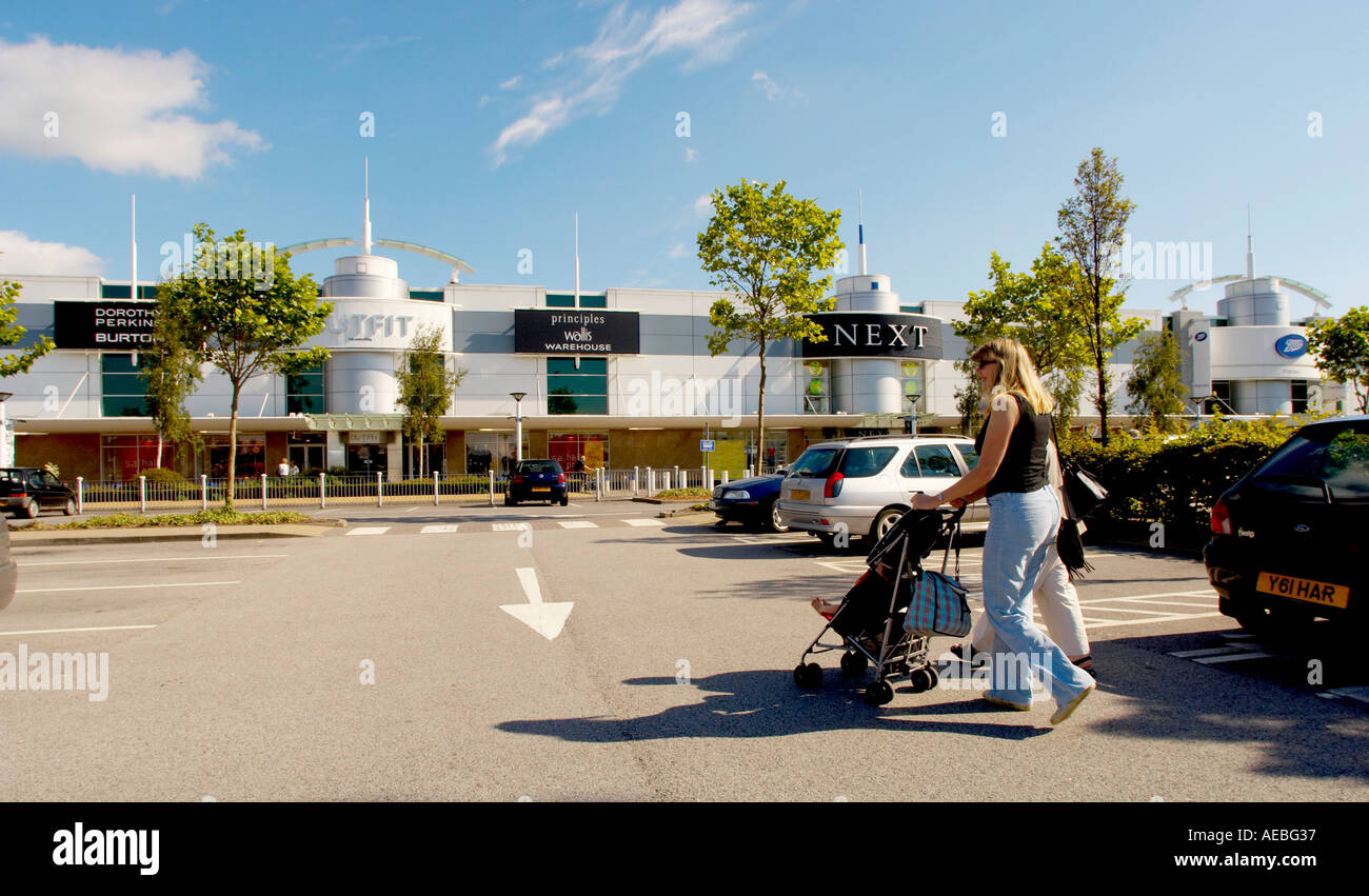 Female shopper with pushchair arriving at Monks Cross Shopping Park ...