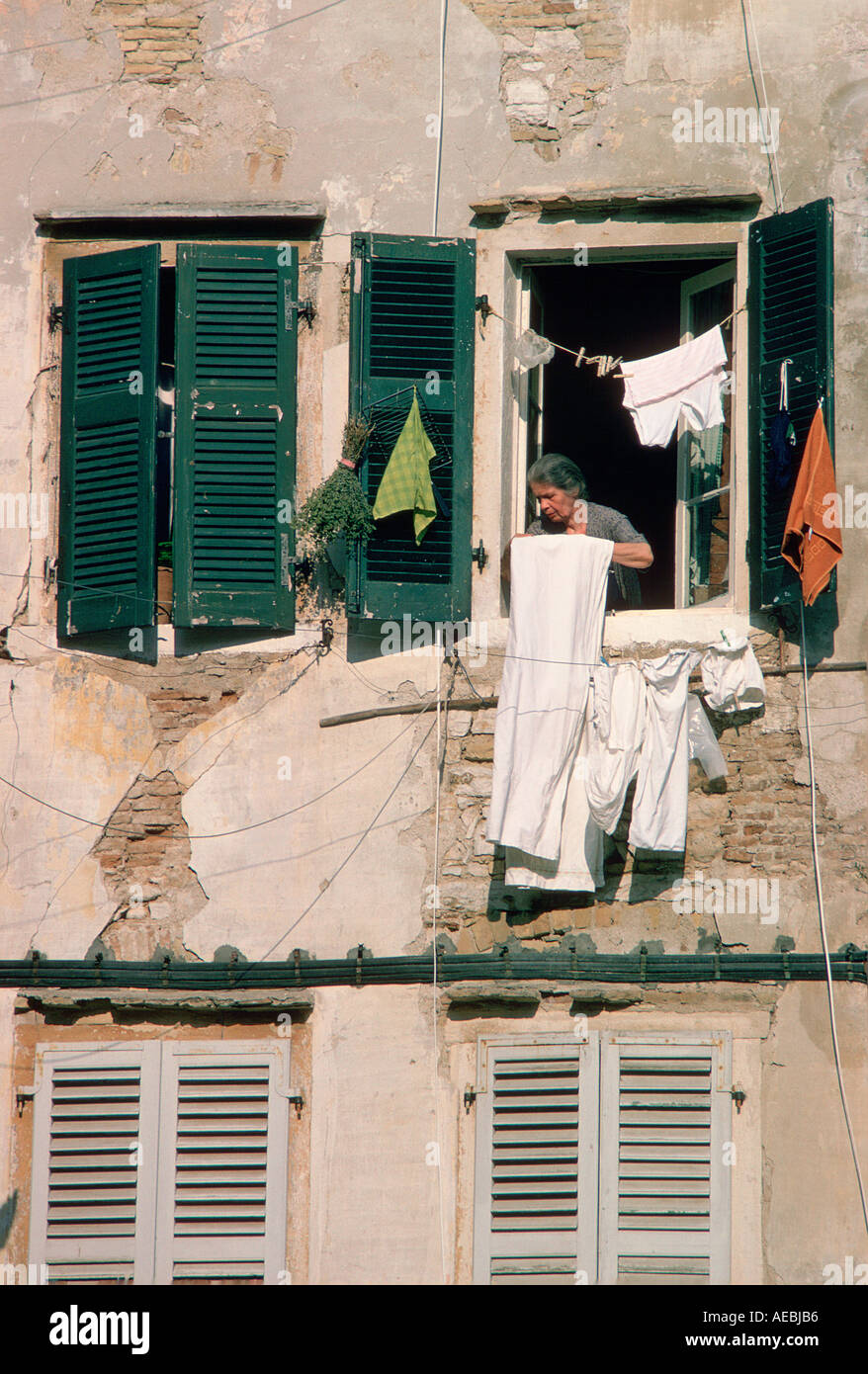 Woman hanging laundry out window hi-res stock photography and images ...