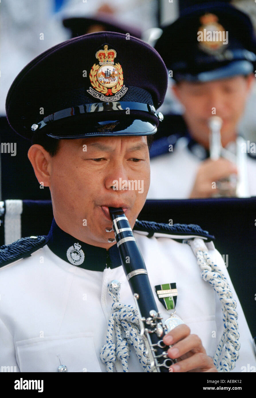 Member of the Hong Kong Police force playing clarinet for the Police ... Member of the Hong Kong Police force playing clarinet for the Police ...