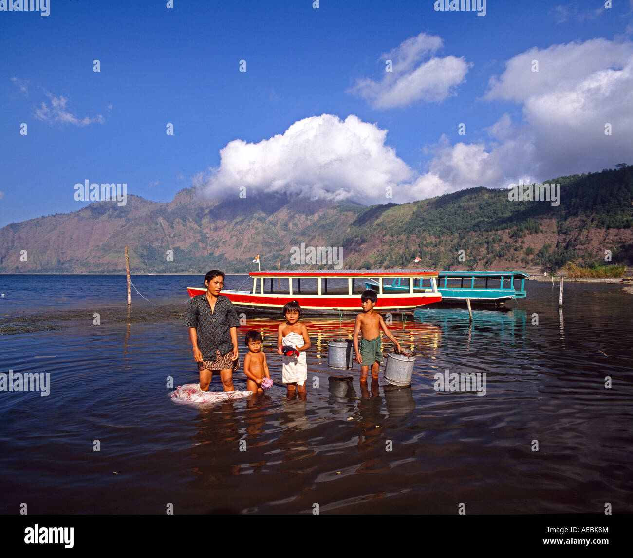 Indonesia Bali portrait of native family standing in lake Stock Photo ...