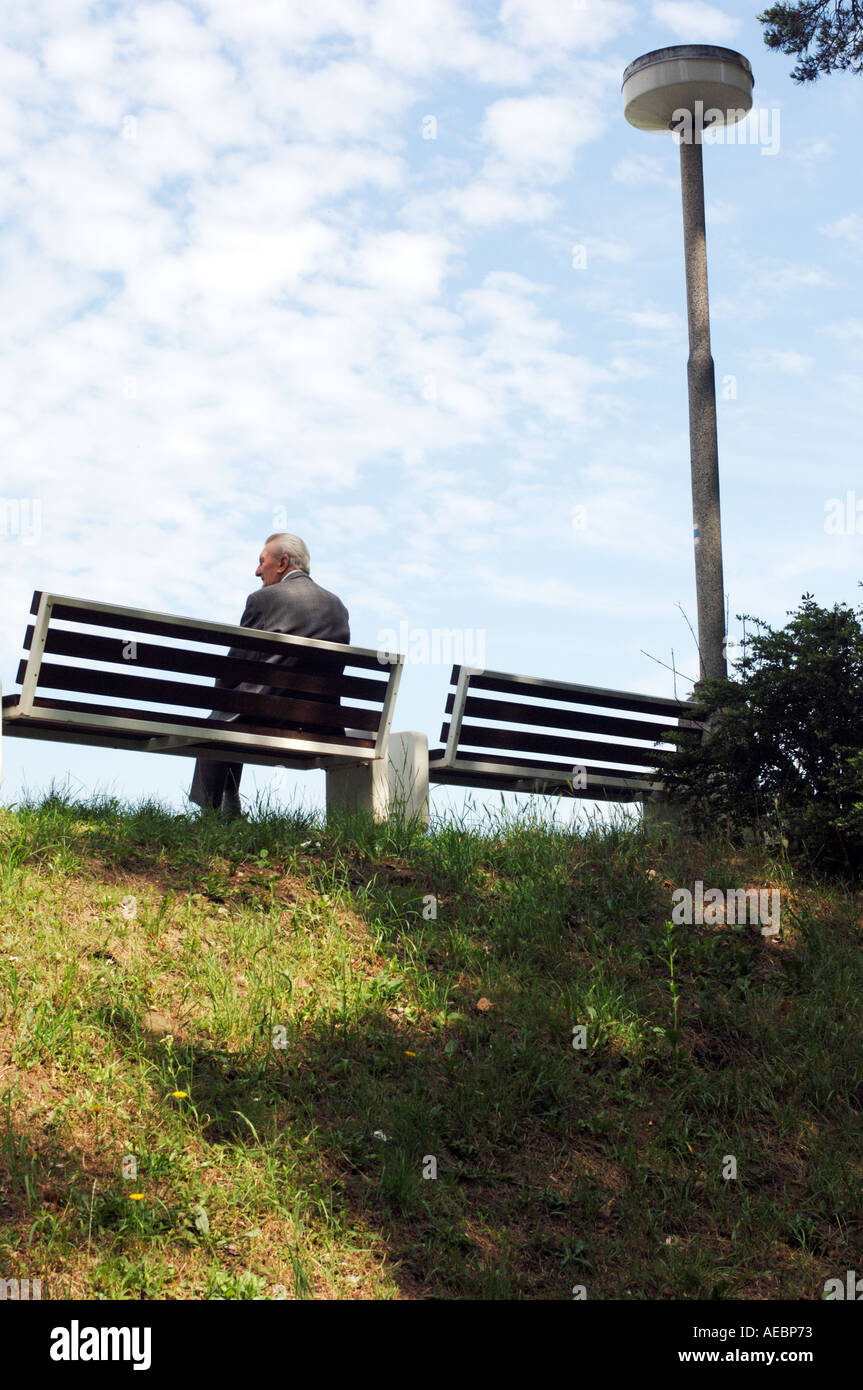 man sitting alone on a bench Stock Photo - Alamy
