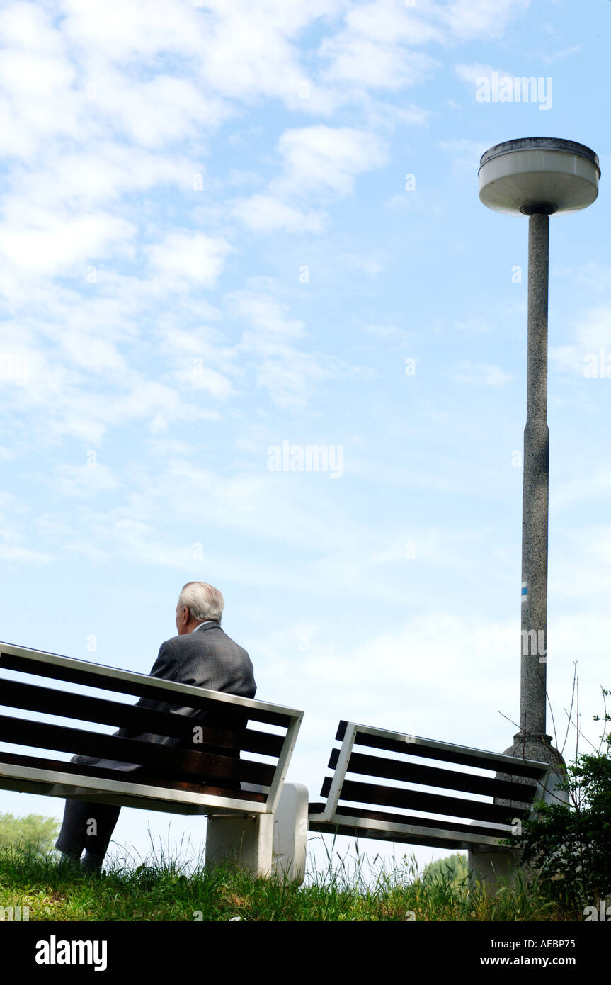 man sitting alone on a bench Stock Photo - Alamy