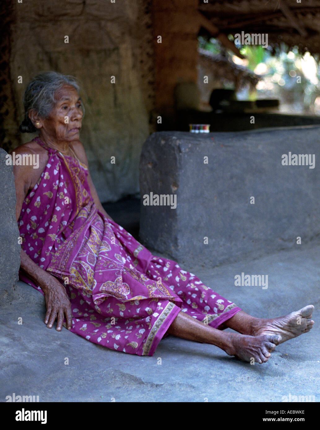 An old tribal woman sitting infront of her hut, Kerala, India Stock ...