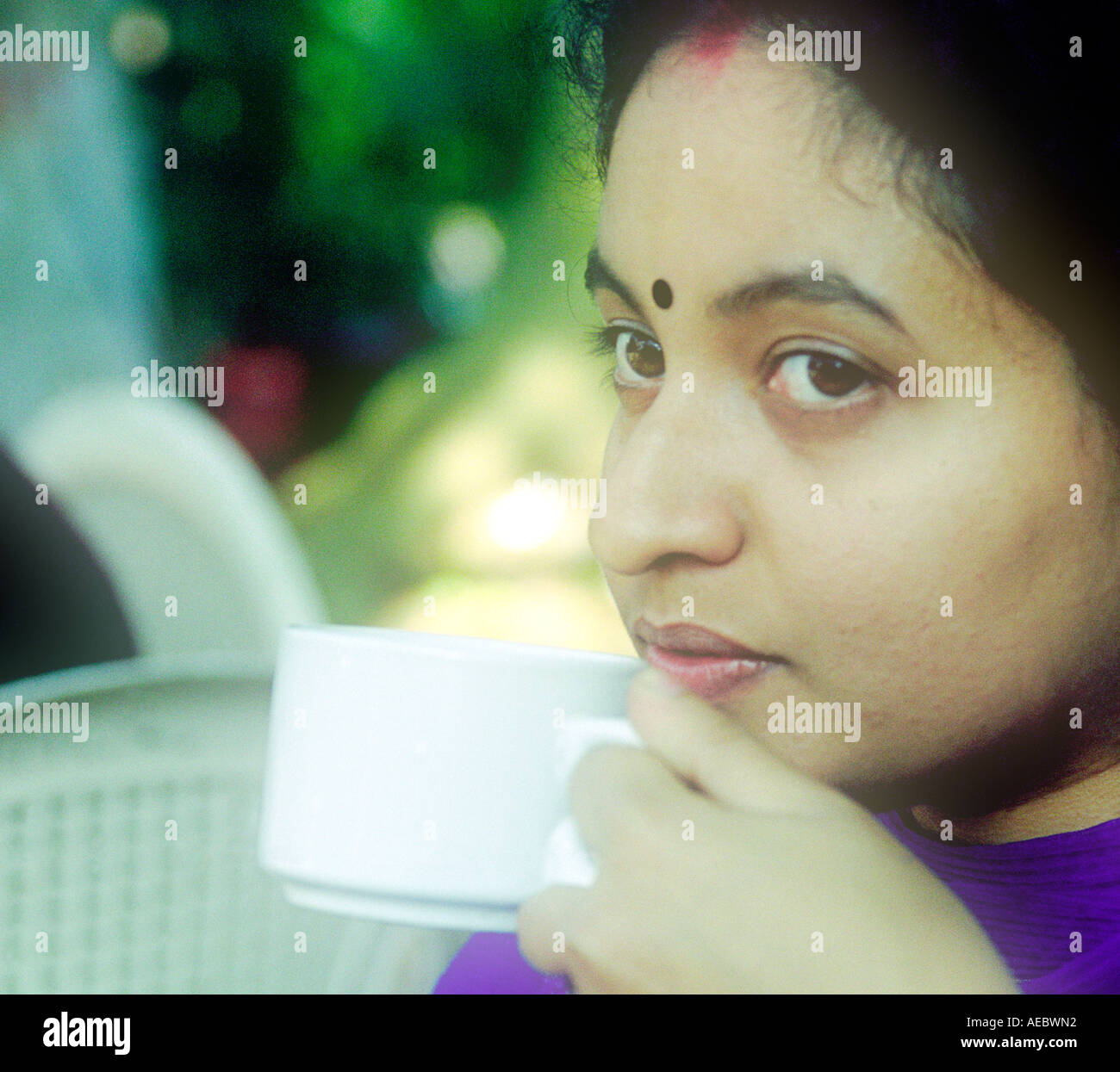 A young Indian lady sipping tea Stock Photo - Alamy