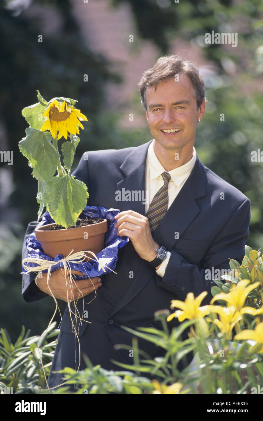 Man with a sunflower Stock Photo - Alamy