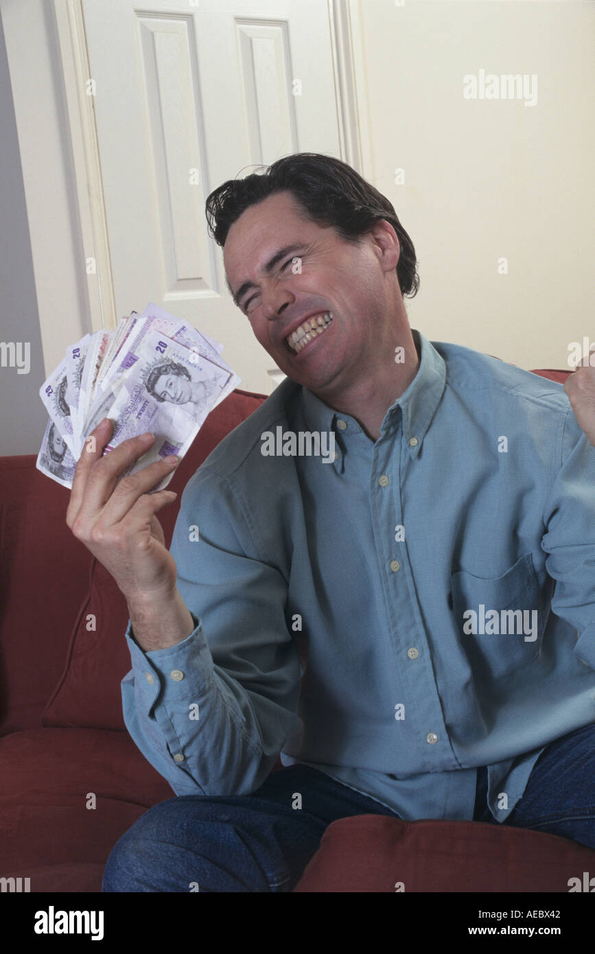 Happy man with lots of money Stock Photo - Alamy