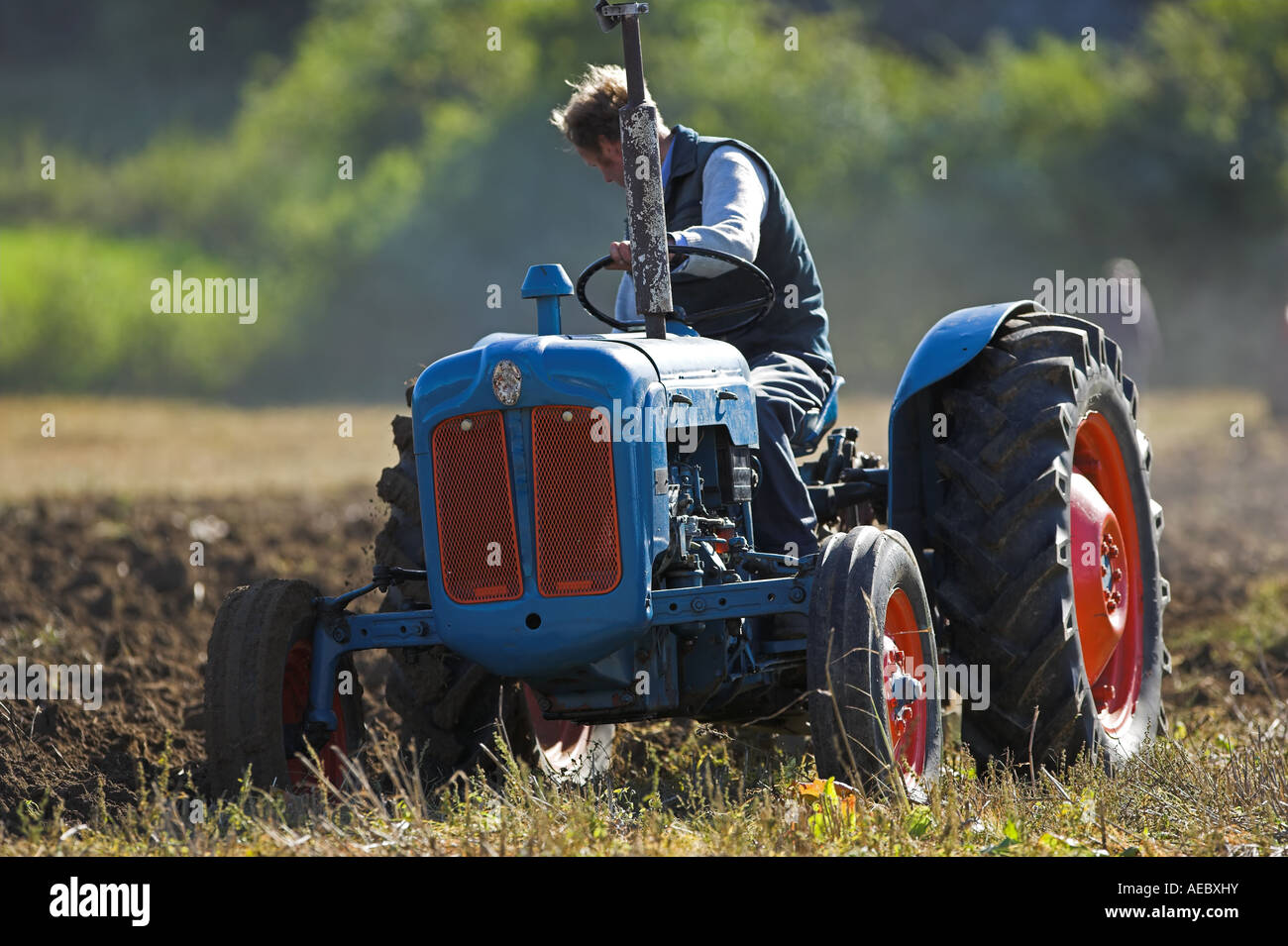 Agricultural Tractor ploughing a field Stock Photo - Alamy