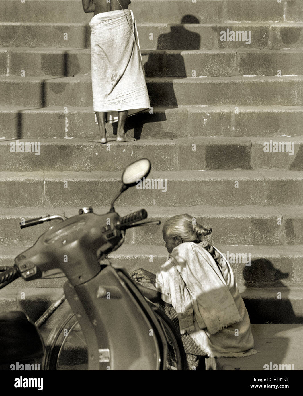 Conceptual image of an old man standing still on steps with a parked ...