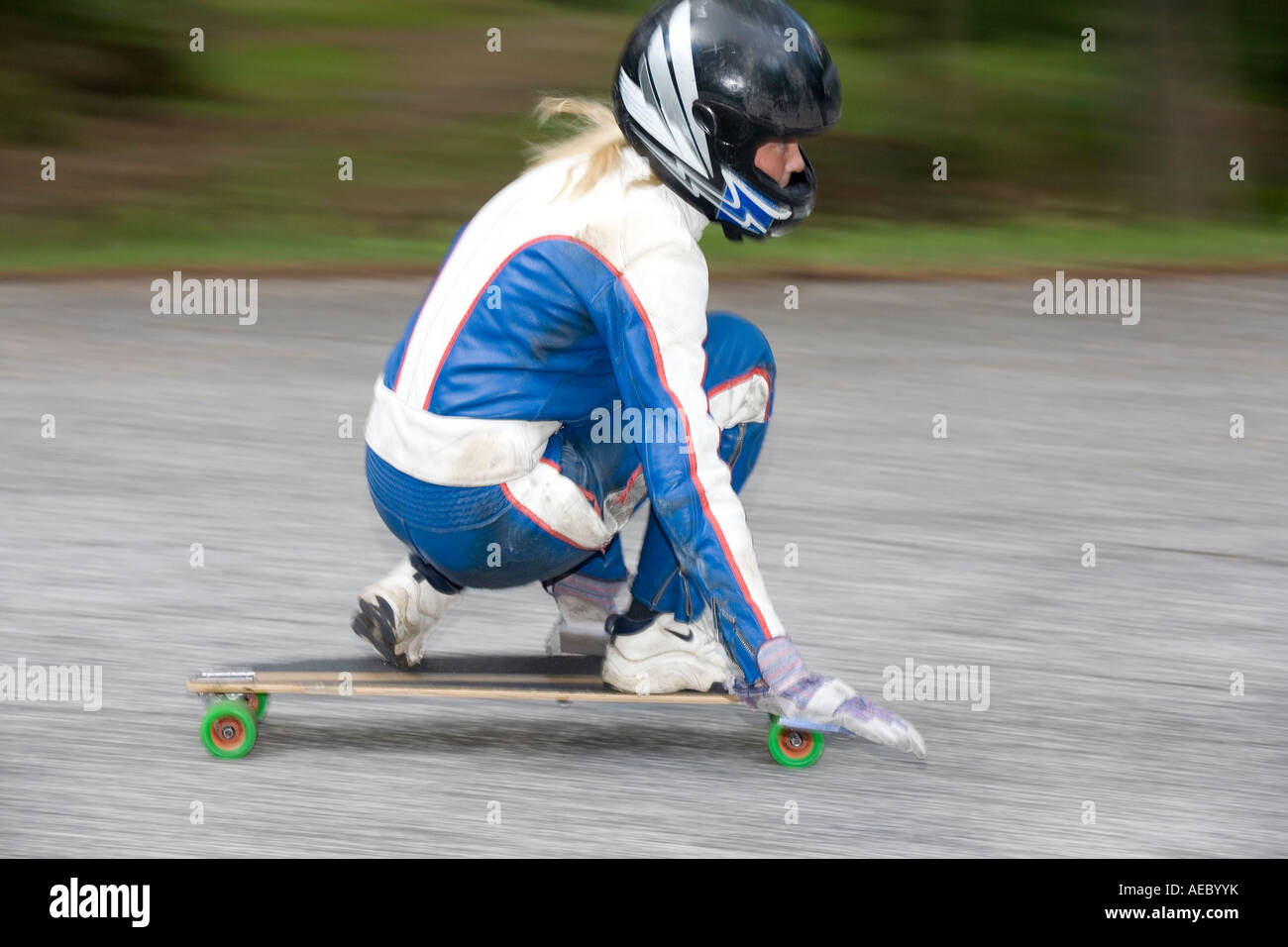 A girl member of Swedish skateboard team speeding down the race ground ...