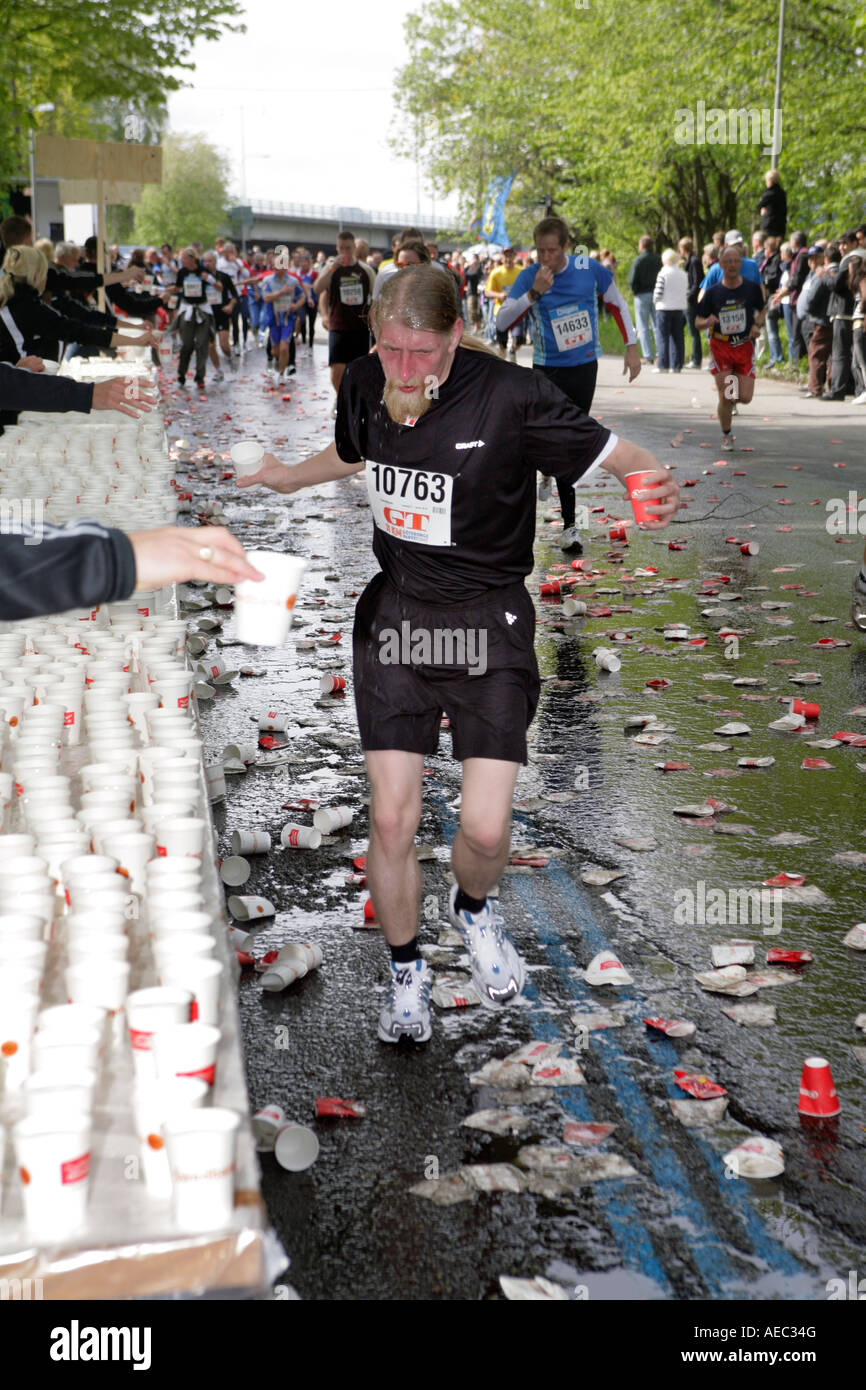 A man reaching refreshment point at marathon run Stock Photo - Alamy