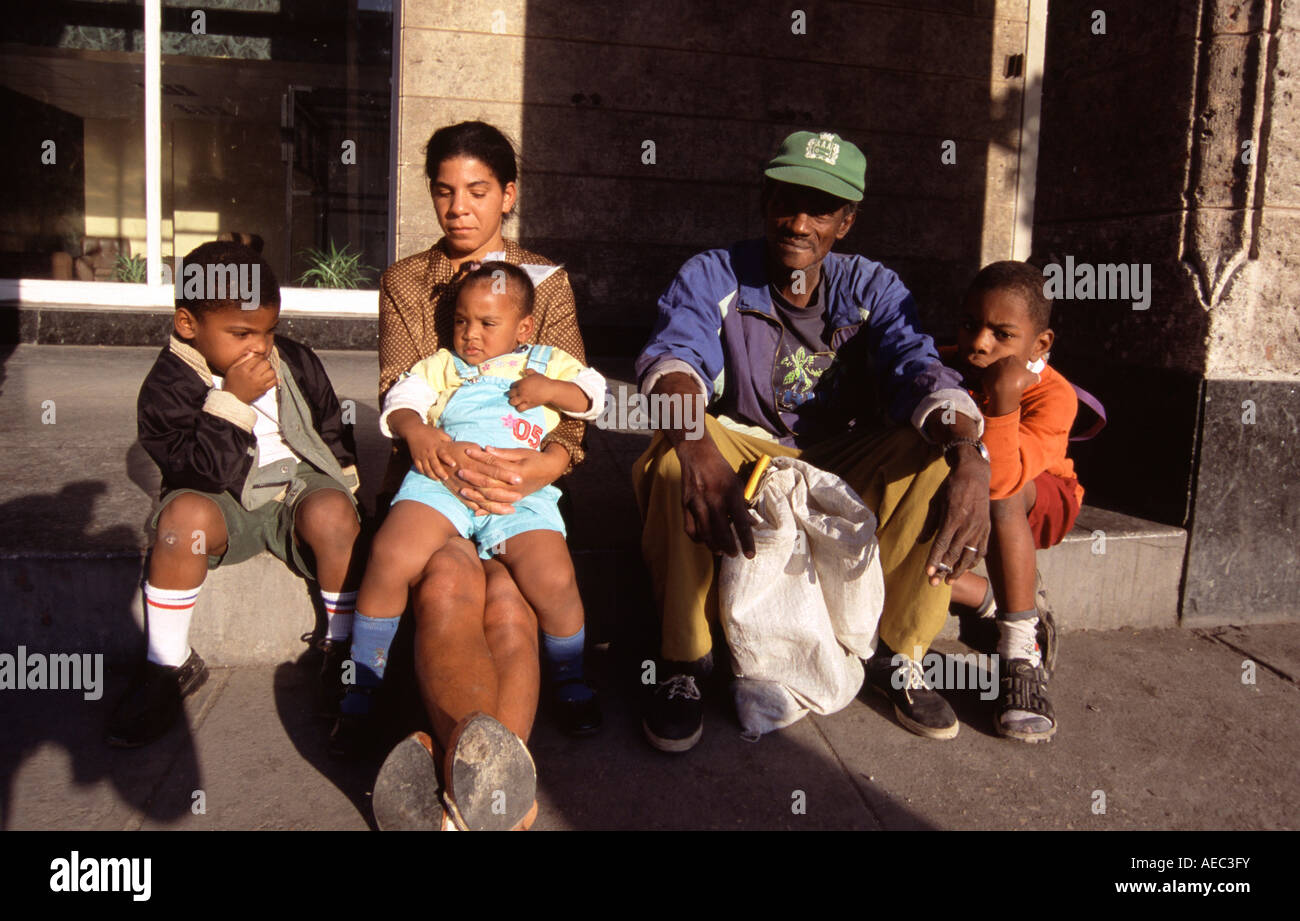Poor Cuban family seating on a sidewalk in Havana Cuba Waiting for the ...
