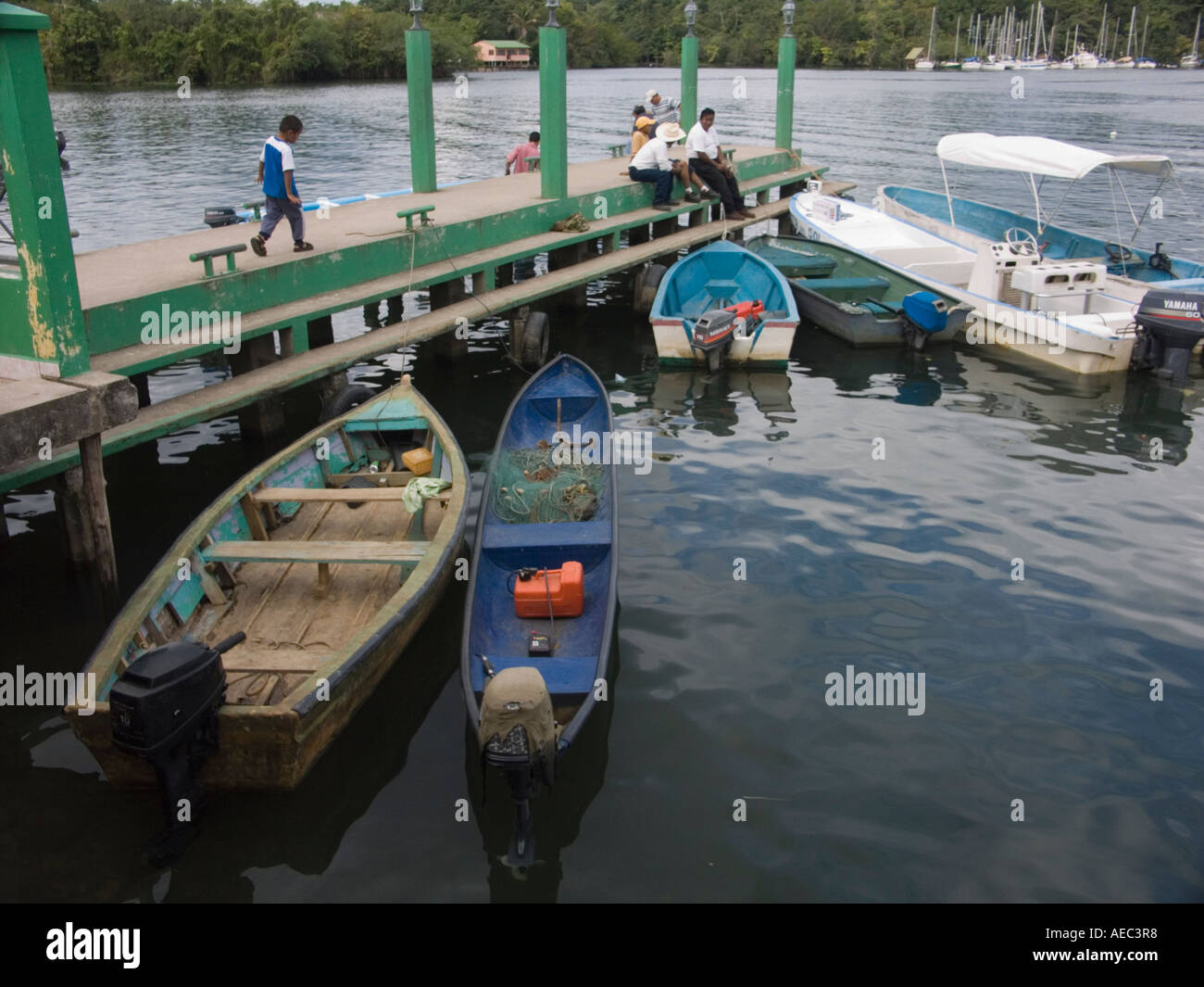 Tourist boats parked on a dock on the river Rio Dulce near the city ...