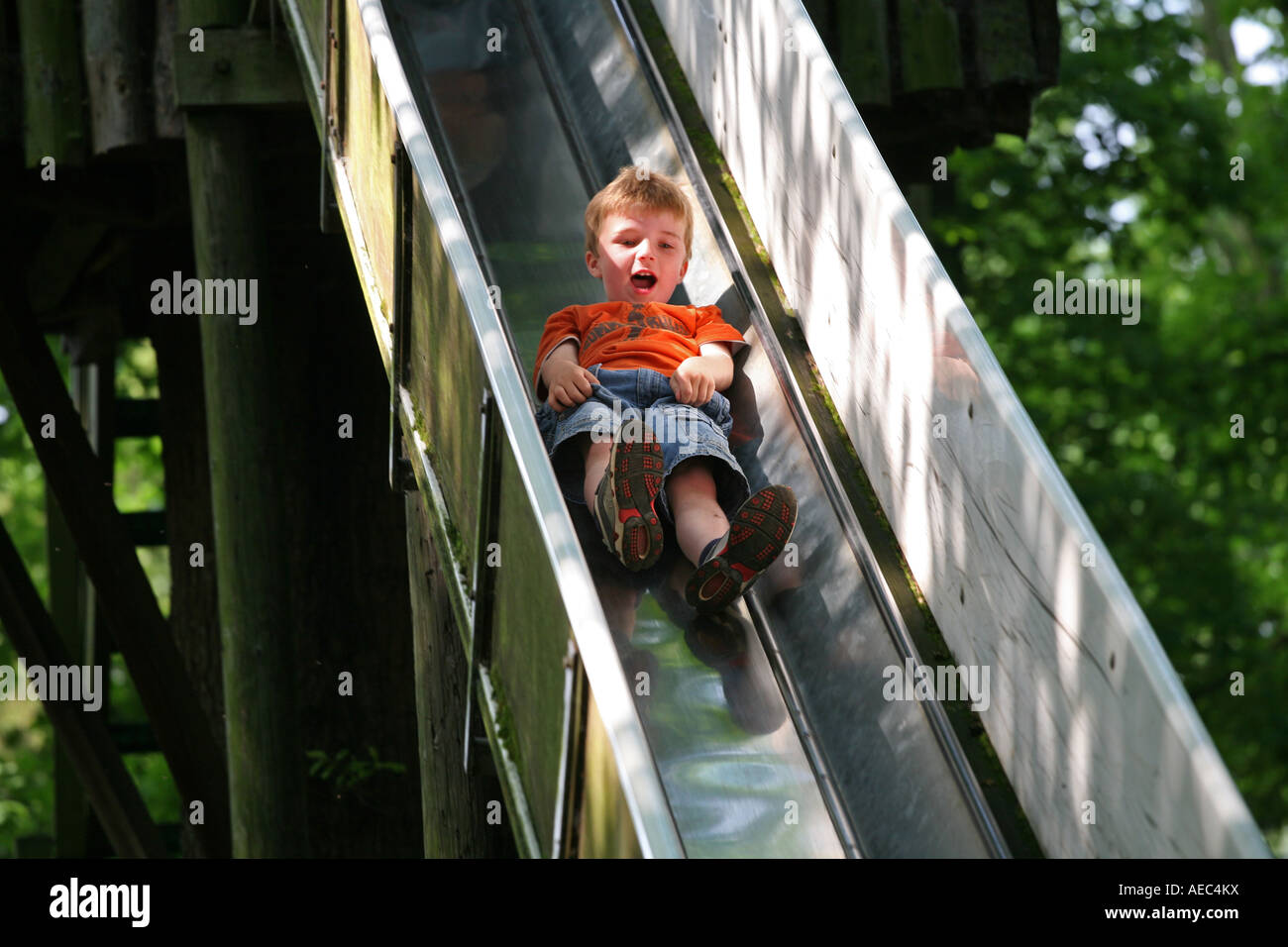 Boy on slide Stock Photo - Alamy