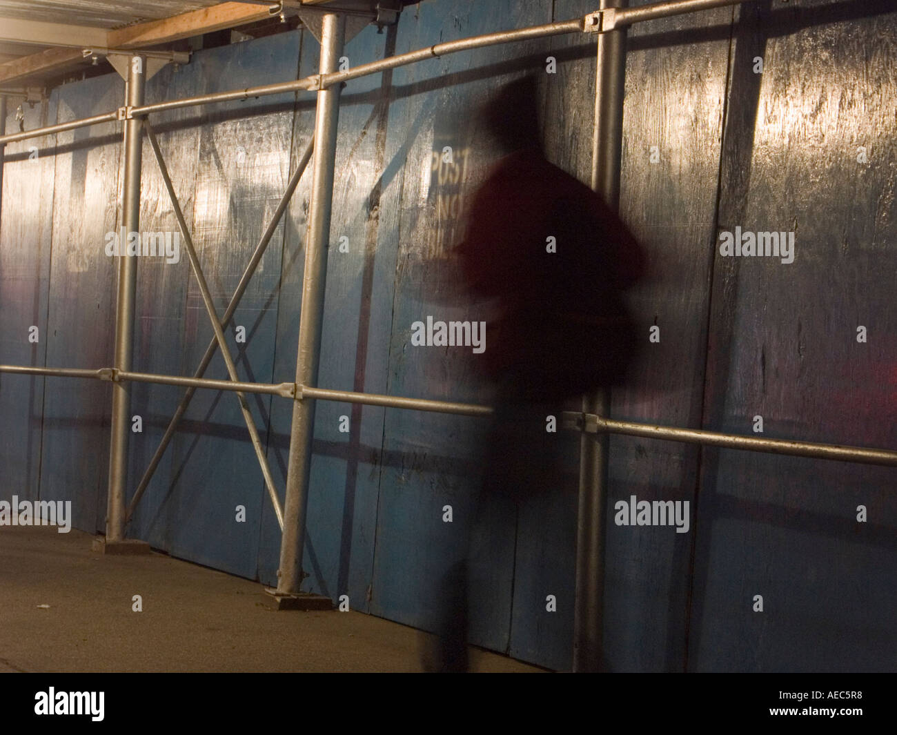 People walk under scaffolding Stock Photo - Alamy