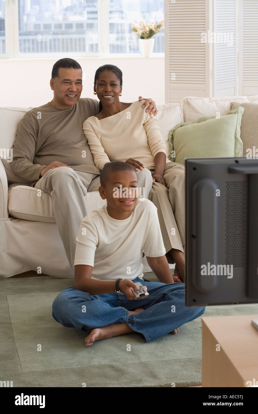 African family watching television in livingroom Stock Photo - Alamy