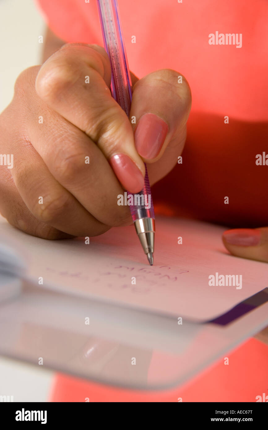 Nurse's hand writing notes, updating patient's history or medical ...