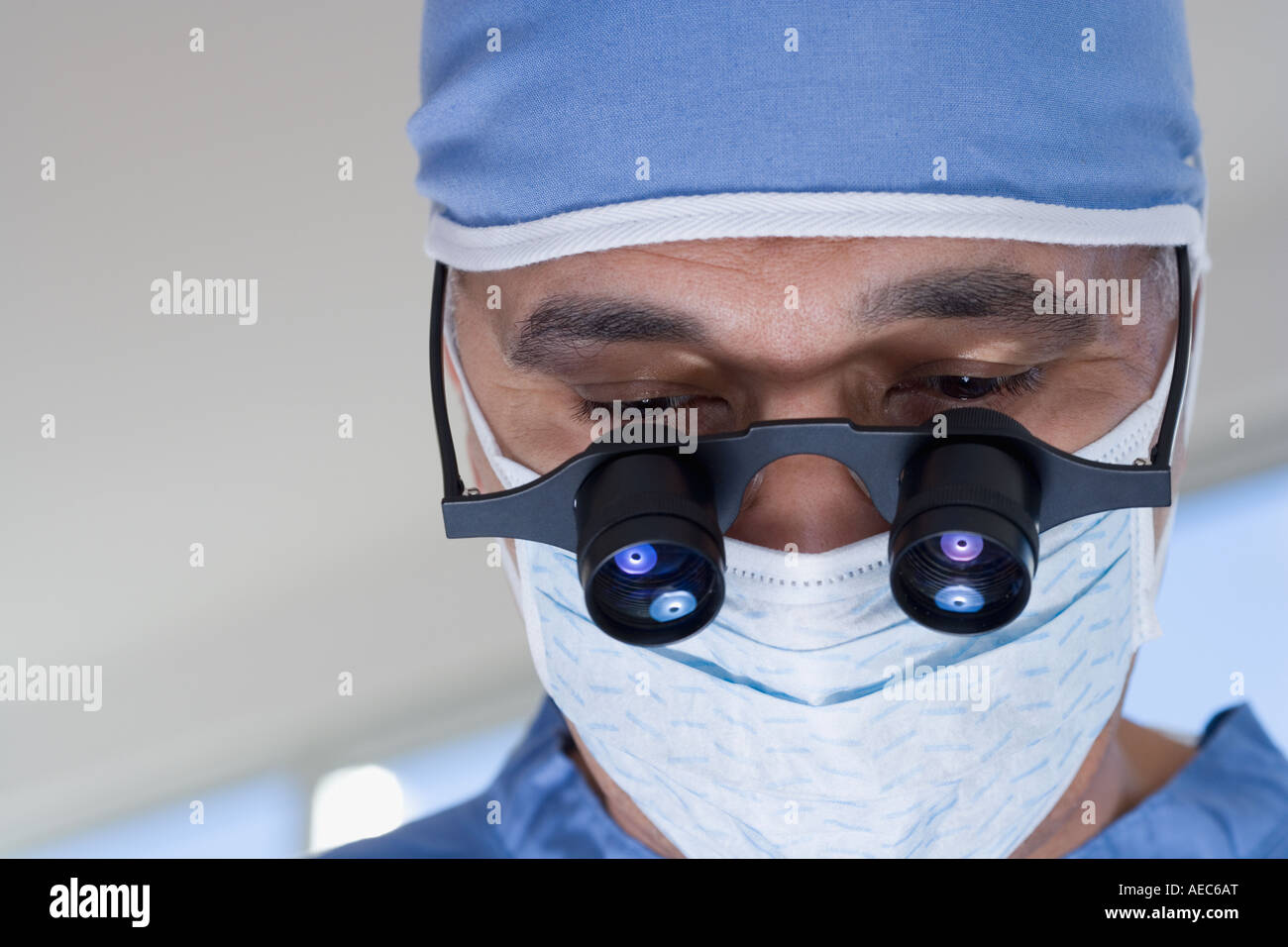 Close up of African male doctor with surgical mask and binocular loupes ...