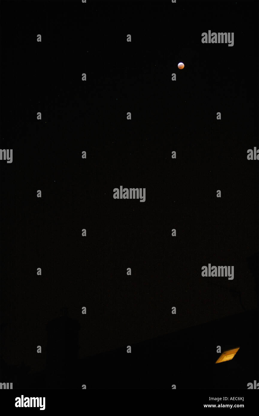 Lunar Eclipse picture above an illuminated house skylight Stock Photo ...