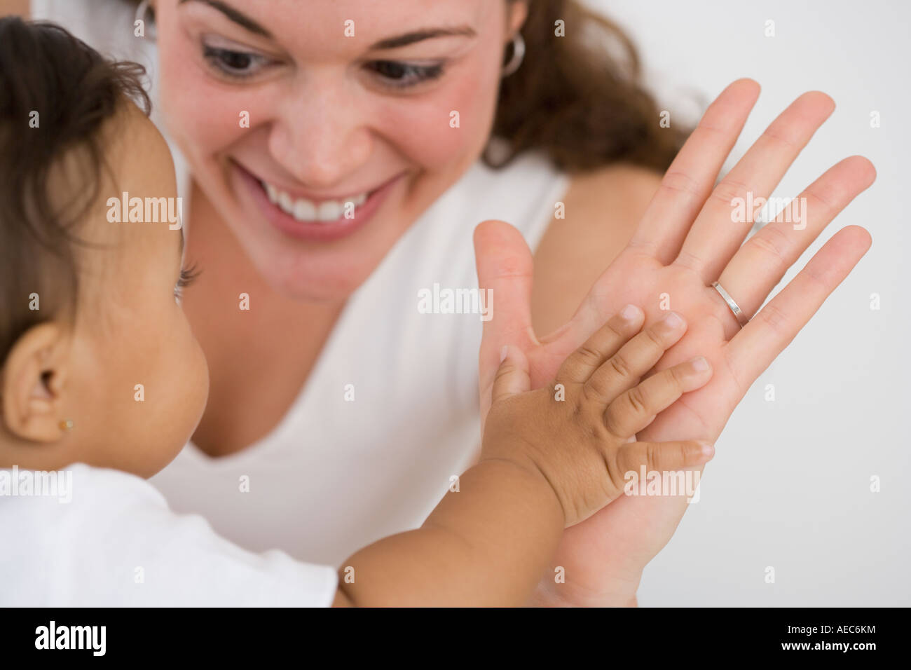 Hispanic mother and baby clapping hands Stock Photo - Alamy