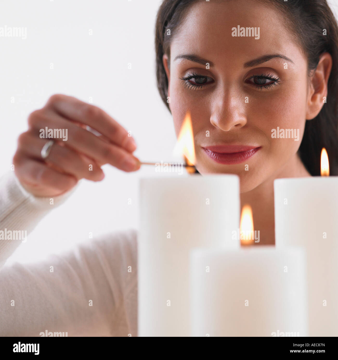 Close up of Hispanic woman lighting candles Stock Photo - Alamy