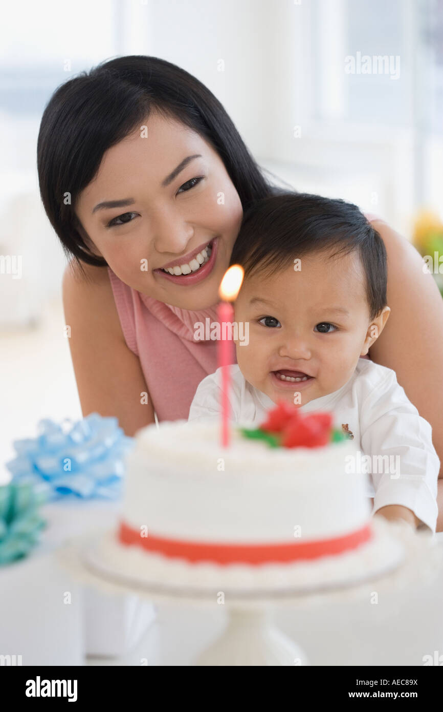Asian mother celebrating baby's first birthday Stock Photo - Alamy