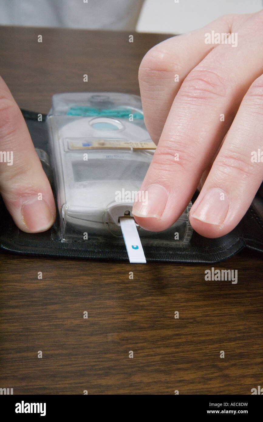 Glucose meter with blood test strip Stock Photo - Alamy