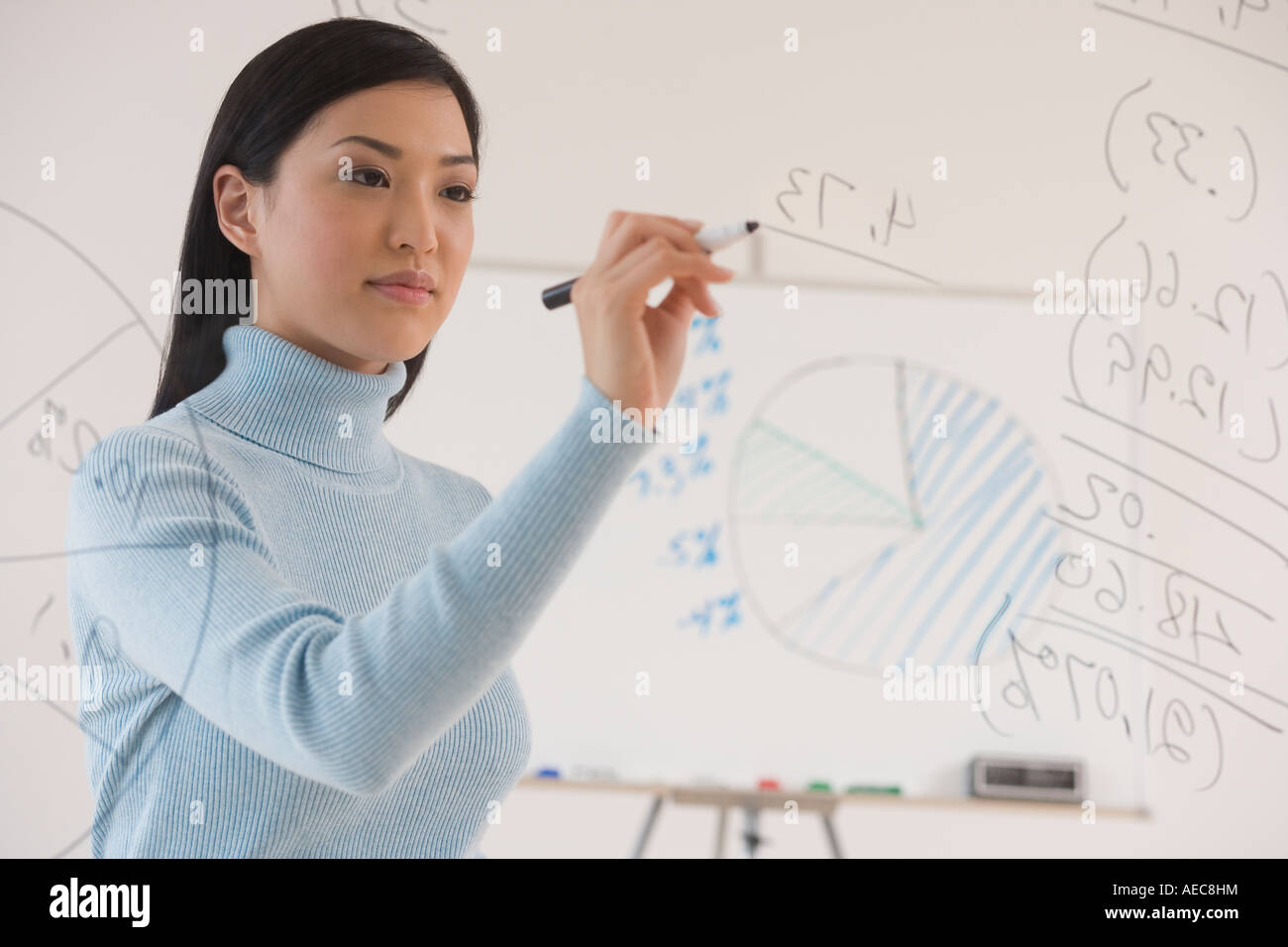 Asian businesswoman writing on white board Stock Photo - Alamy