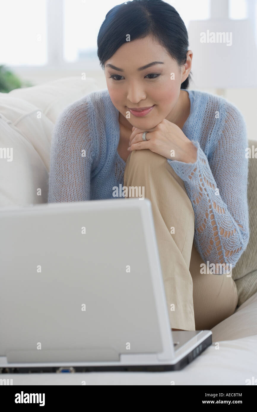 Women using laptop in sofa hi-res stock photography and images - Alamy