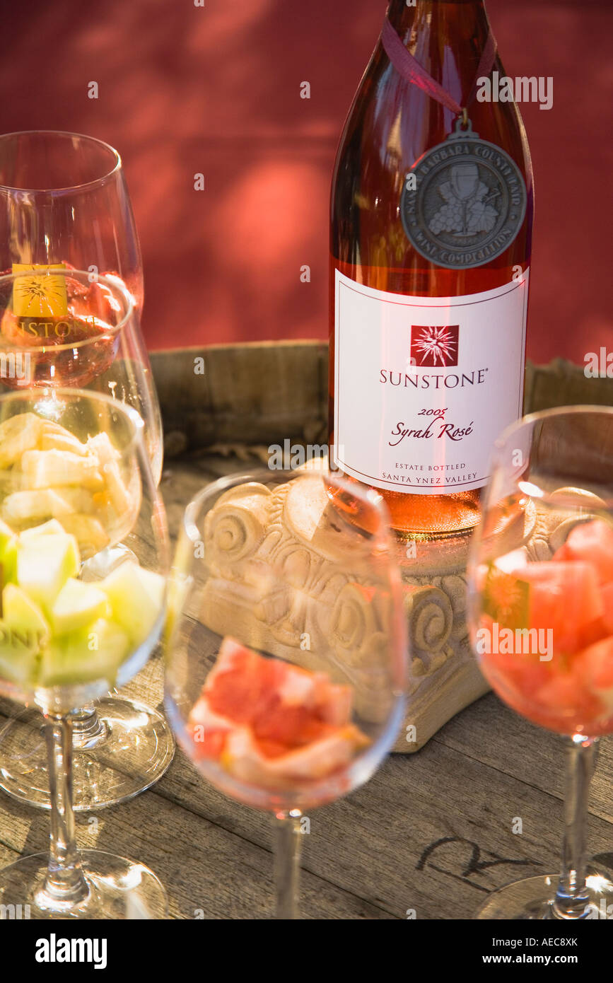 bottle of Syrah Rose wine surrounded by glasses of fruits noticeable in ...