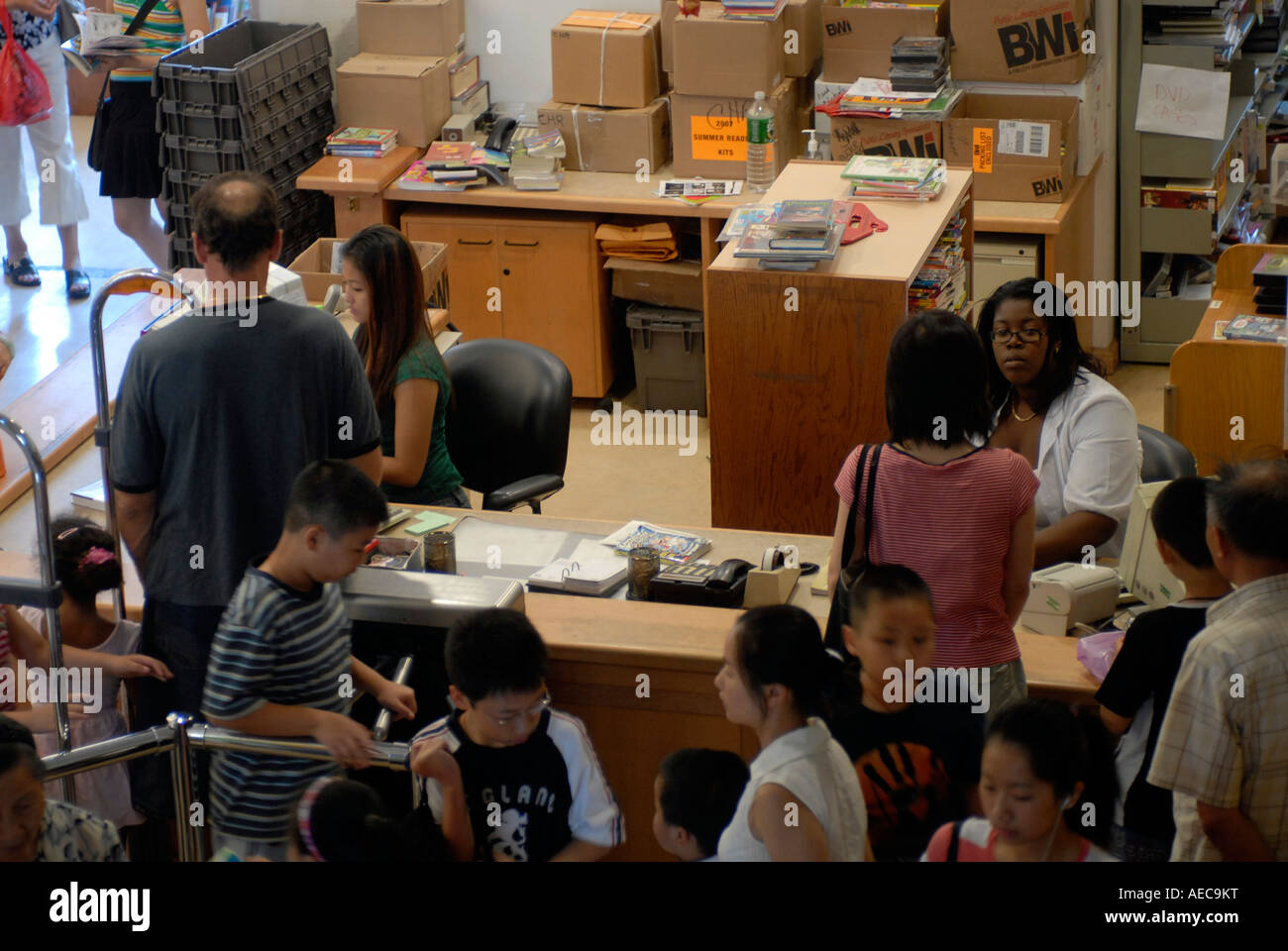 Library customers check in and out at the front desk in the Chatham ...