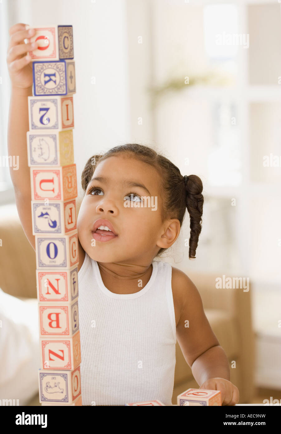 African girl building tower of blocks Stock Photo - Alamy