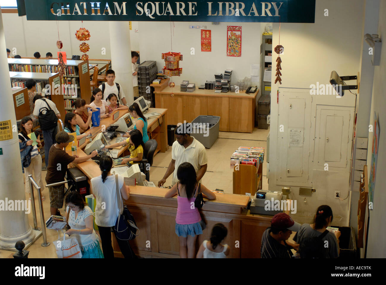 Library customers check in and out at the front desk in the Chatham ...