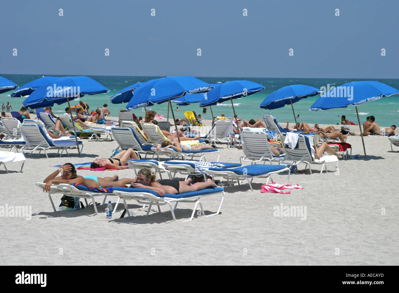 sunbathers and umbrellas on beach Stock Photo - Alamy