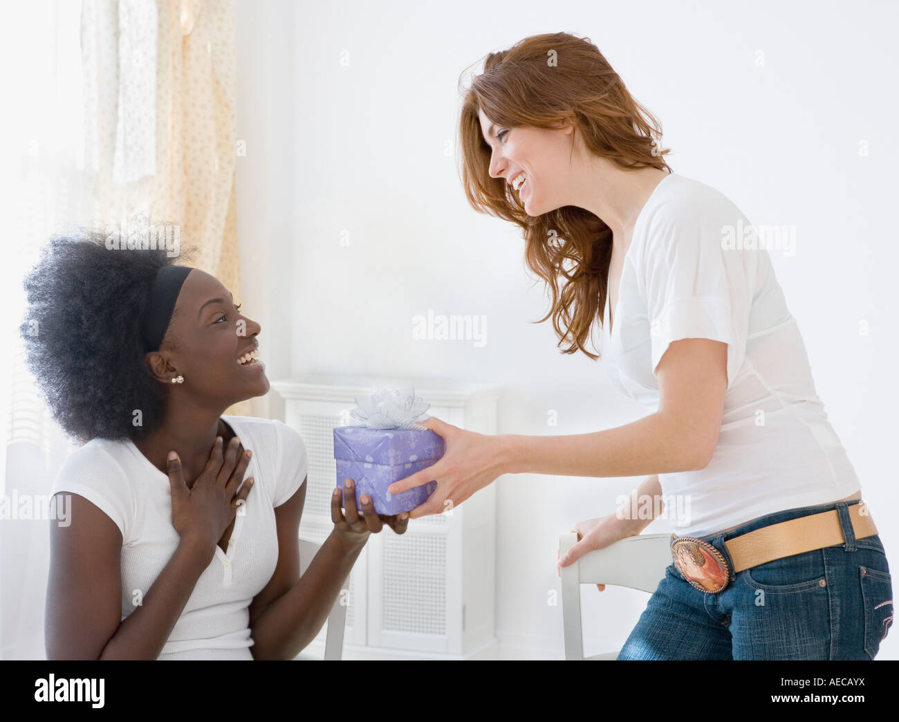 Two women exchanging gifts Stock Photo - Alamy