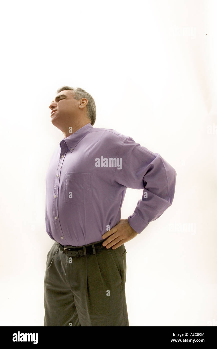 Middle aged man with back pain Stock Photo - Alamy