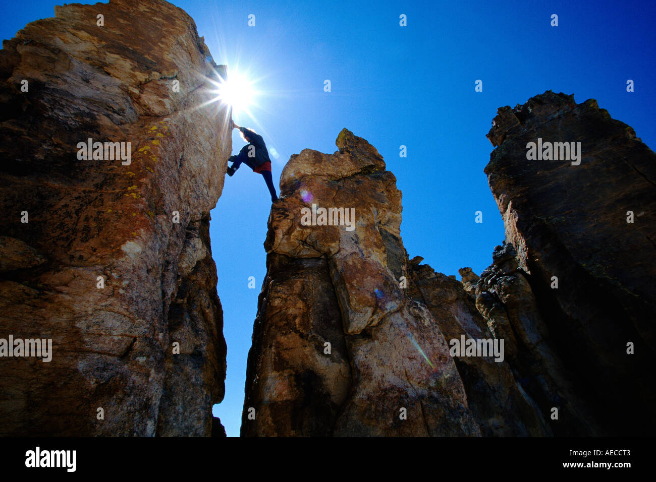 man climbing rock spire in Yankee Boy Basin area, Sneffels range, San ...