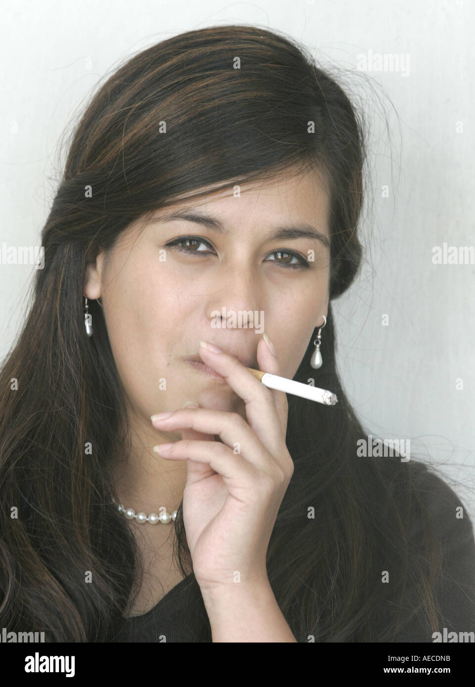 Brunette smoking a cigarette hi-res stock photography and images - Alamy