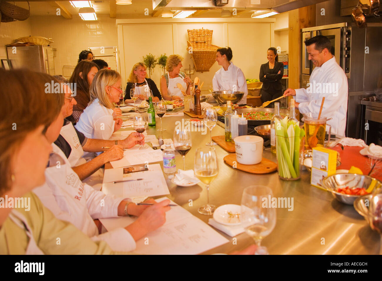 a chef prepares a traditional Spanish dish of paella at a cooking class ...