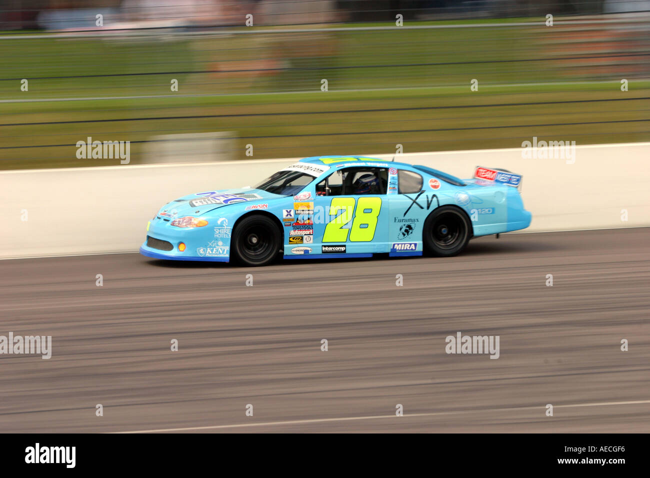V8 Nascar type stock cars racing on a banked oval circuit Stock Photo ...