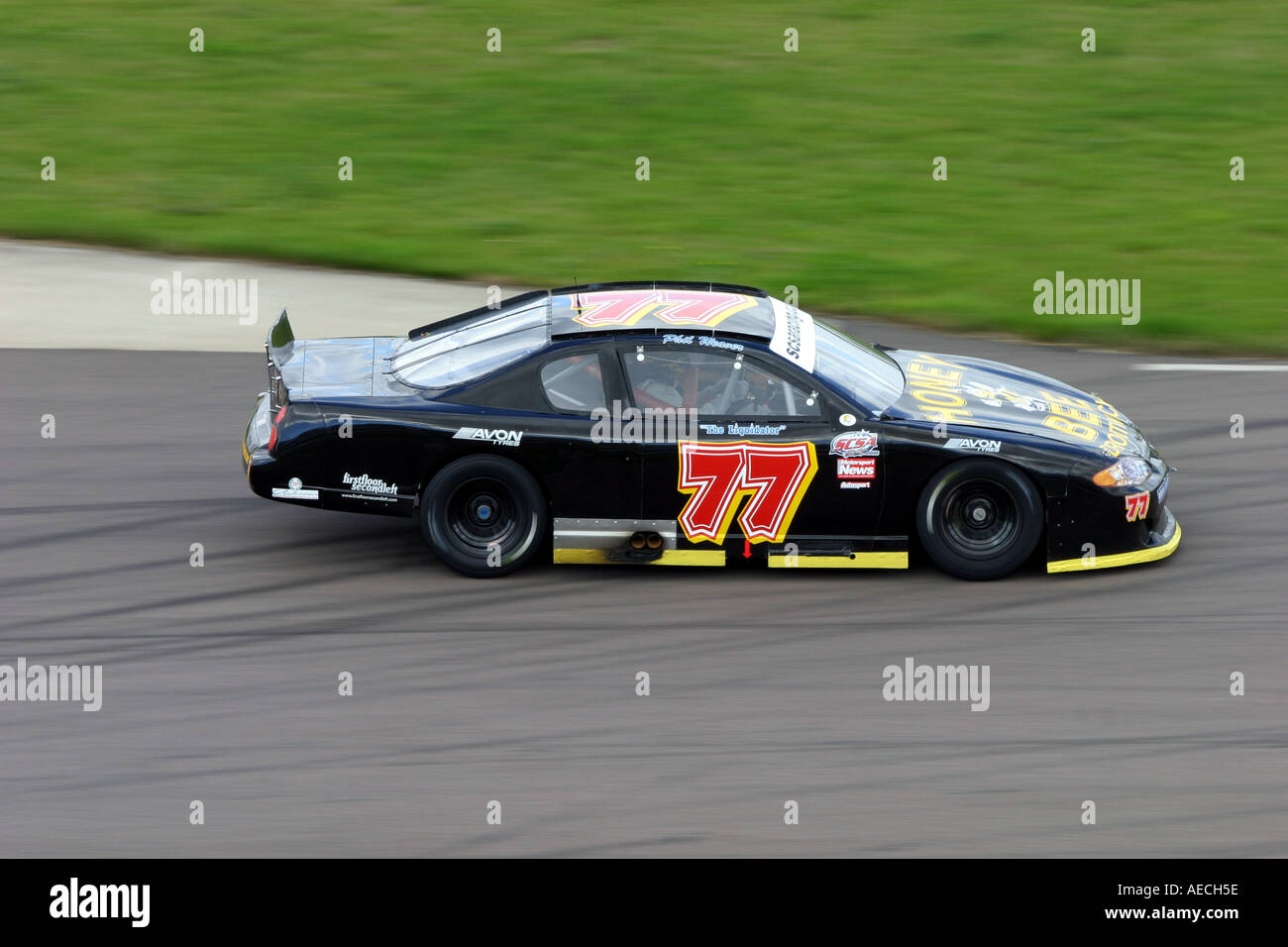 V8 Nascar type stock cars racing on a banked oval circuit Stock Photo ...