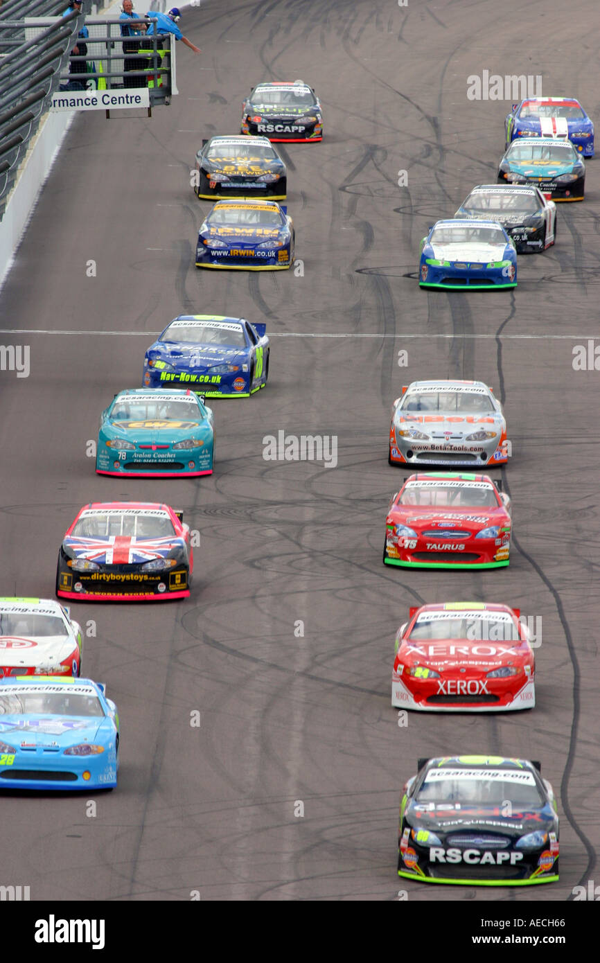 V8 Nascar type stock cars racing on a banked oval circuit Stock Photo ...