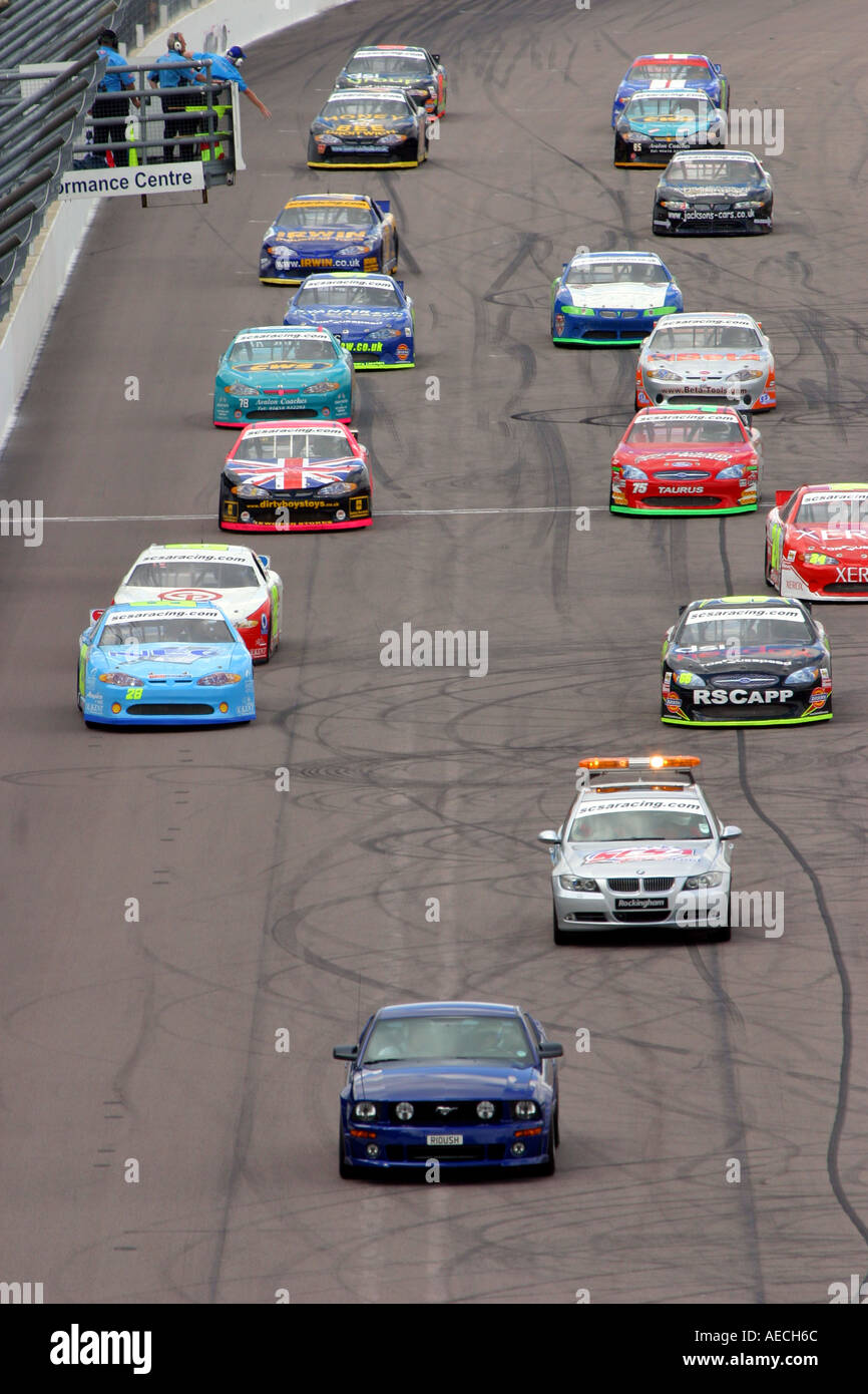 V8 Nascar type stock cars racing on a banked oval circuit Stock Photo ...
